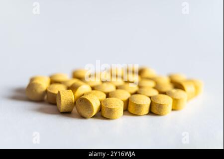 Medical tablets, placed next to each other on a white surface ...