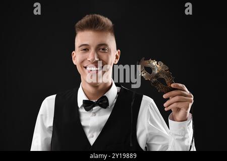 Charming young man with carnival mask on light blue background Stock ...