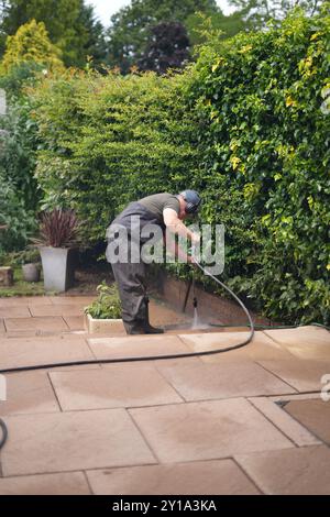 power washing - man cleaning terrace with a power washer - high water ...