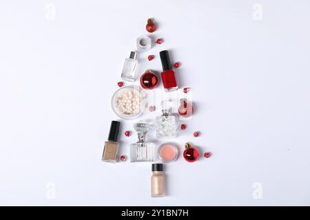 Christmas tree shape made of perfume bottles and cosmetic products on ...