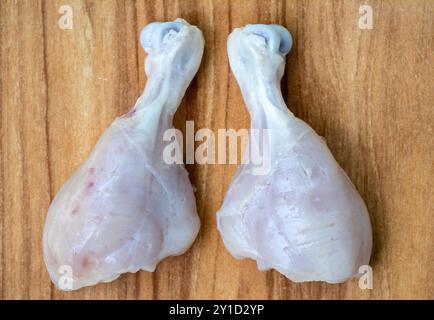 Raw chicken legs on wooden table Stock Photo - Alamy