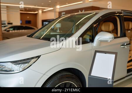 Car dealership information stand with blank mockup sheet displaying ...