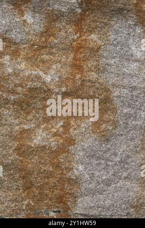 Close up photo of a granulated rock texture. The rock contains whites ...
