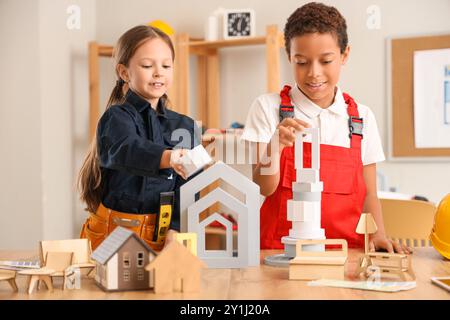 Cute little architects building houses with figures at home Stock Photo ...