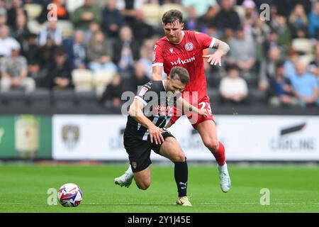 Nicholas Tsaroulla of Notts County fouls Rosaire Longelo of Salford ...
