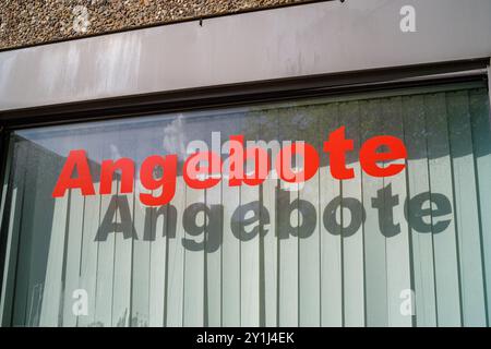 Dilapidated storefront window displays the word "Angebote" ("Offers" in ...