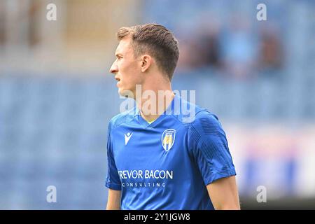 Colchester United goalkeeper Matt Macey (right) punches clear from ...
