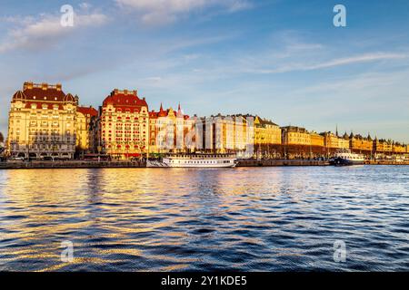 View of historic buildings along Nybroviken at sunset, Stockholm ...