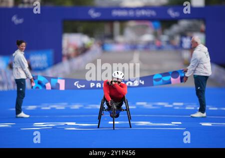 Switzerland's Catherine Debrunner crosses the finish line to win gold ...