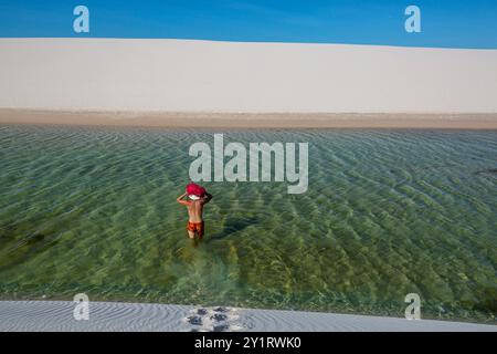 Tourist among lagoons in the desert of Lencois Maranhenses National ...