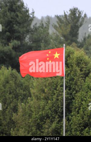 National flag of China on a flagpole in front of blue sky Stock Photo ...