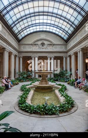 people rest in the atrium of the Frick Collection, former 5th Avenue ...