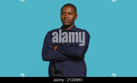 Security guard in threatening pose, tasked with preventing criminal ...