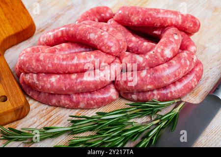 Sausage, lard and meat products. Sausages on a wooden cutting board ...