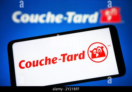 In this photo illustration, the logo of Couche - Tard is displayed on ...
