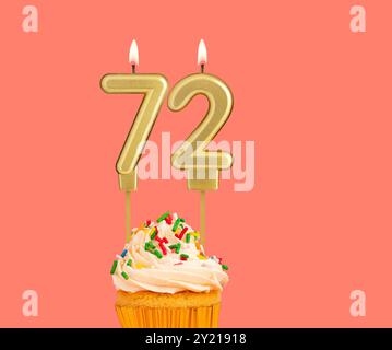 Birthday cupcake with number 72 candle - Green background with blue ...