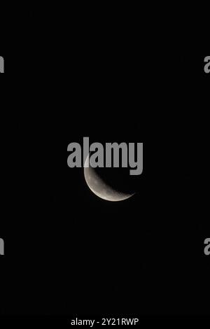 A vertical shot of a crescent moon in a bright sunset sky Stock Photo ...