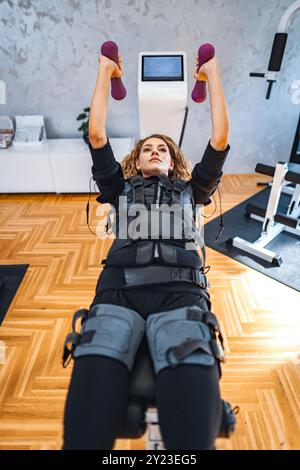 Empowered strength training session with muscle stimulation Stock Photo ...