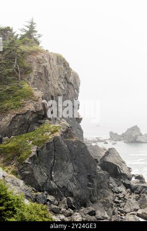 Scenic rocky shoreline with rugged cliff edges and crystal-clear water ...