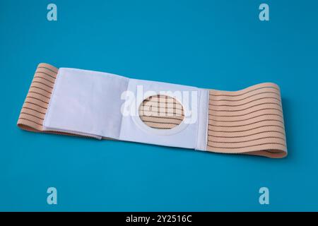 an unfolded abdominal belt, with a stoma opening for colostomy patients ...