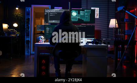 Experienced hacker writing lines of code on computer from underground ...