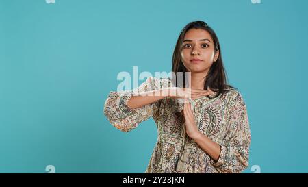 Portrait of assertive woman asking for timeout, doing hand gestures ...
