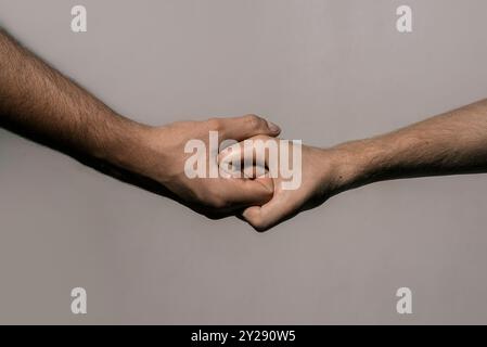 Male hand united in handshake. Man help hands, guardianship, protection ...