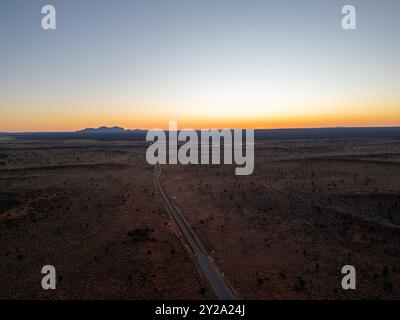 A breathtaking aerial view of Uluru Rock in Australia illuminated by a ...