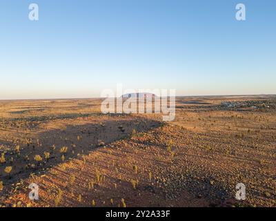 A breathtaking aerial view of Uluru Rock in Australia illuminated by a ...