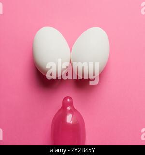 Egg, condom and studio background as contraceptive for birth rate ...