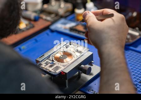 Technician replacing electronic control board inside disassembled ...