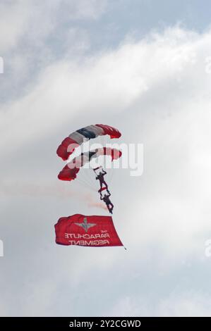 Two of the The Red Devils parachute team joined together with flag ...