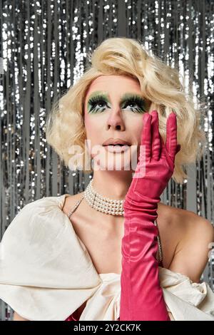 A vibrant drag artist showcases their stylish outfit and poses ...