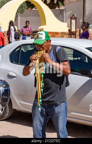 An indigenous man plays the siku panpipes plays for a religious ...