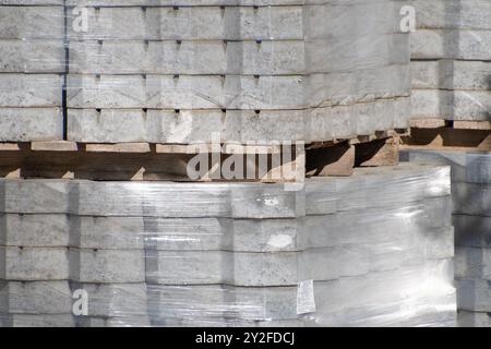 Packing concrete blocks for paving. Construction work. Construction ...
