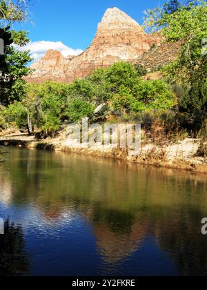 The majestic peak of the Watchman towering over the fast flowing Virgin ...