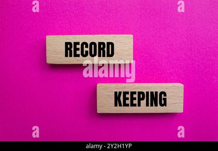 Record keeping message written on wooden blocks with brown background ...