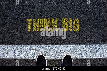 Think big message written on movie clapper board with orange background ...