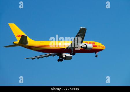 Plane Airbus A300 DHL cargo airplane in flight with clear blue sky ...