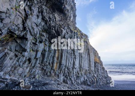 Towering basalt columns create a dramatic backdrop at Reynisfjara ...