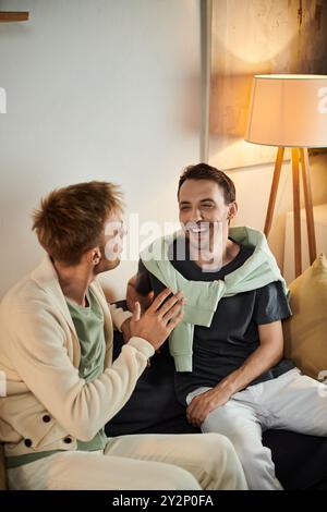 Two men share laughter and warmth while enjoying a cozy afternoon at ...