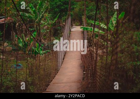 Suspension bridge in poor shape viewed from one side as part of ...