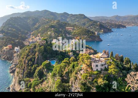 Aerial view of luxury boats and villas on Mediterranean Sea framed by ...