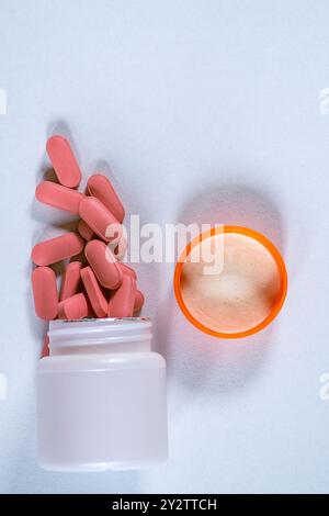 Open Pill Bottle with Scattered Red Tablets on White Background Stock ...