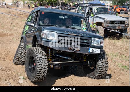 Modified blue Land Rover Discovery Series I splashing through mud. High ...