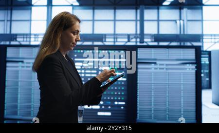 Technician doing checkup using tablet to prolong data center ...