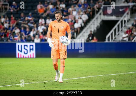 New Zealand goalkeeper Max Crocombe, center, falls backwards after ...
