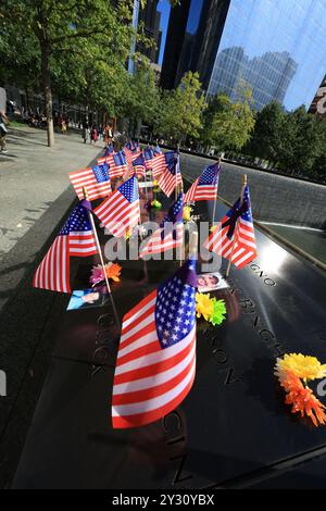 Visitors place flags and take photos at the South Pool, one of two ...