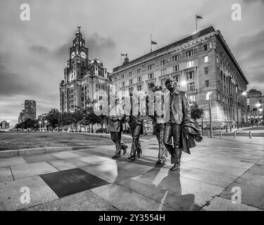 This image is the statue of the Liverpool music group the Beatles who ...