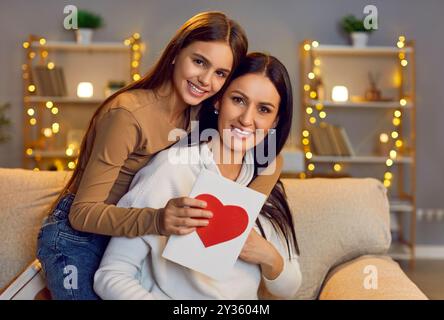 Mother's day concept. Child daughter congratulates mom and gives her ...